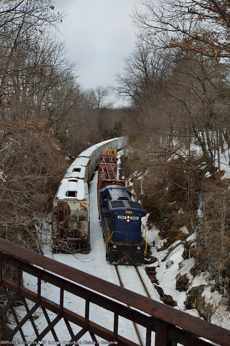 EPRY 3153 passing stored cars with the Main St bridge in the forground.